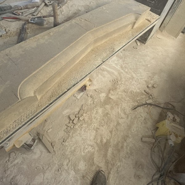 Stone fireplace lintel being carved today